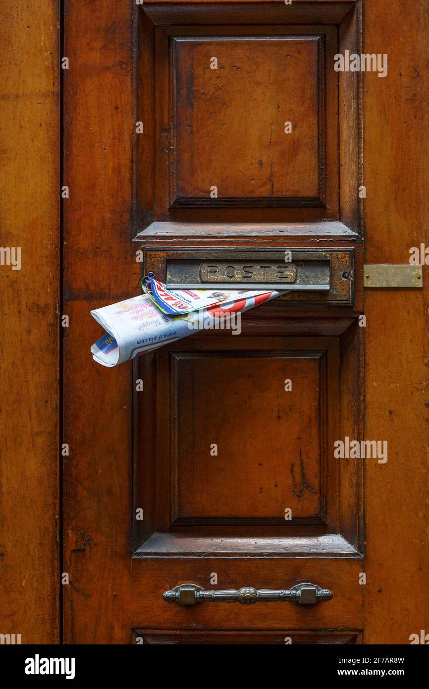 Advertising in a mail box in a door Stock Photo - Alamy
