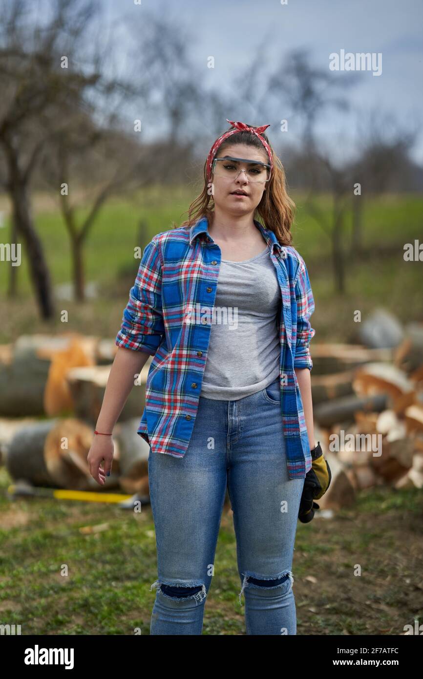 Woman farmer splitting beech logs for firewood in the backyard Stock ...
