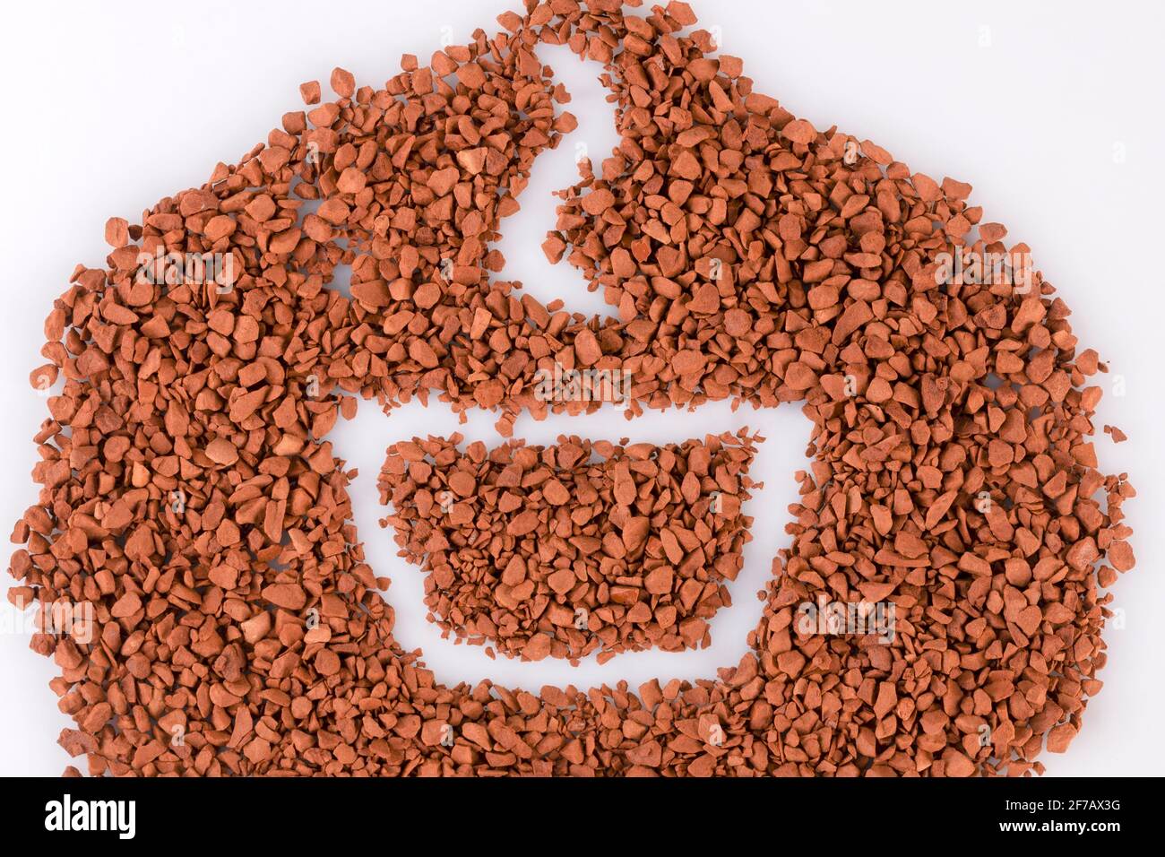 Instant coffee granules lying on the surface. A cup of coffee drawn on ...