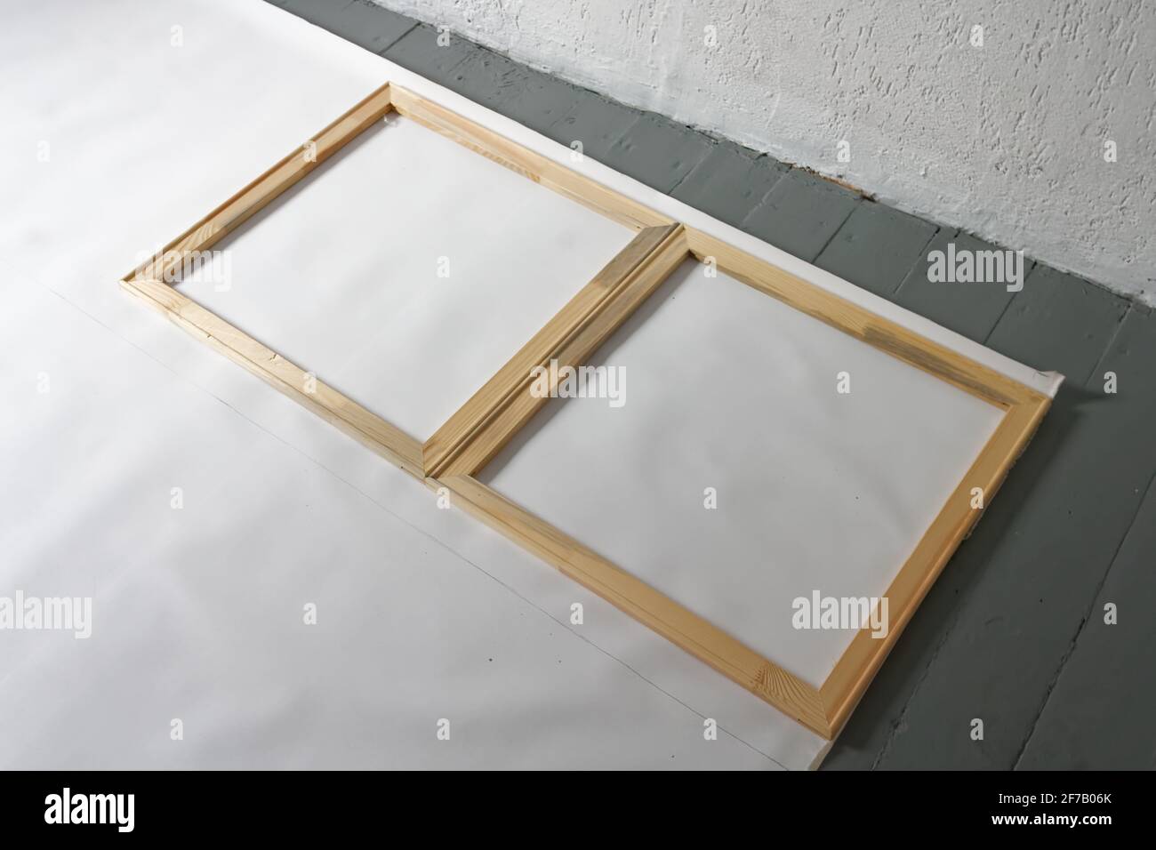 A female artist cutting canvas to prepare her own picture supports ...