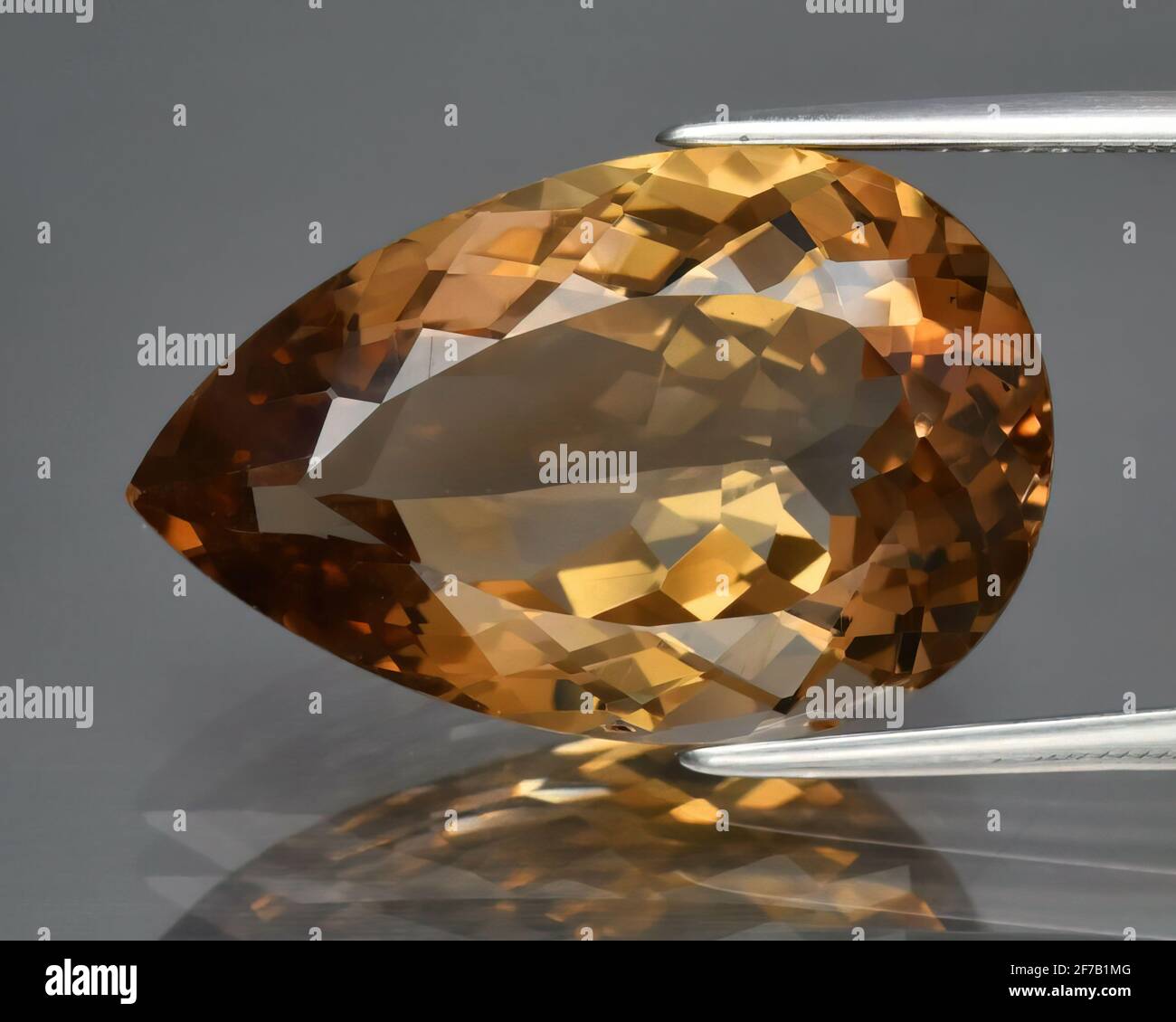 Natural gemstone orange imperial topaz on gray background Stock Photo ...