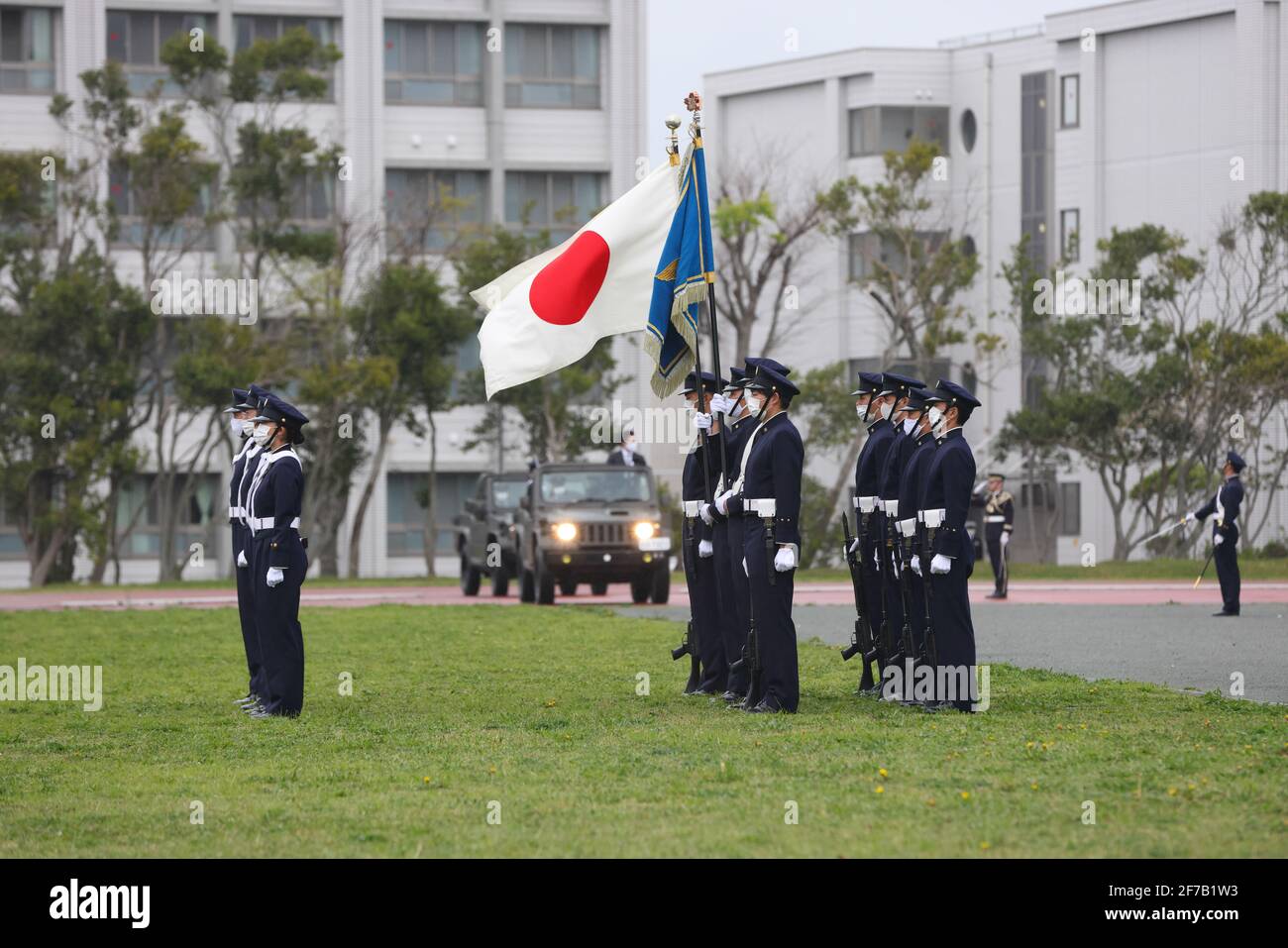 Students present the Japanese flag during a military parade in honor of ...