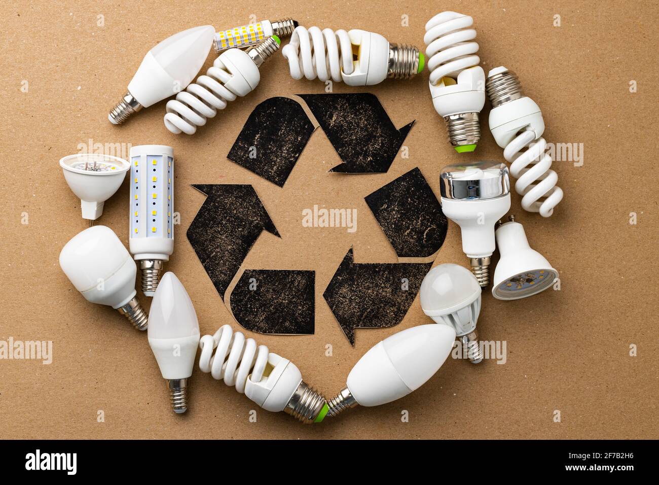 Recycling symbol surrounded by used light bulbs on craft paper Stock ...