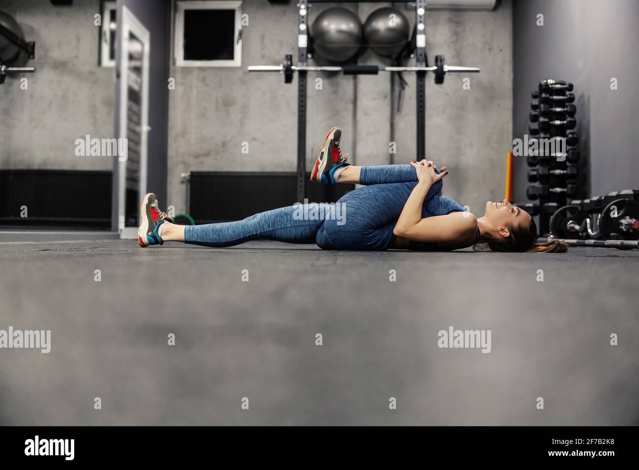 Stretching the leg muscles. An elastic woman in good physical shape ...