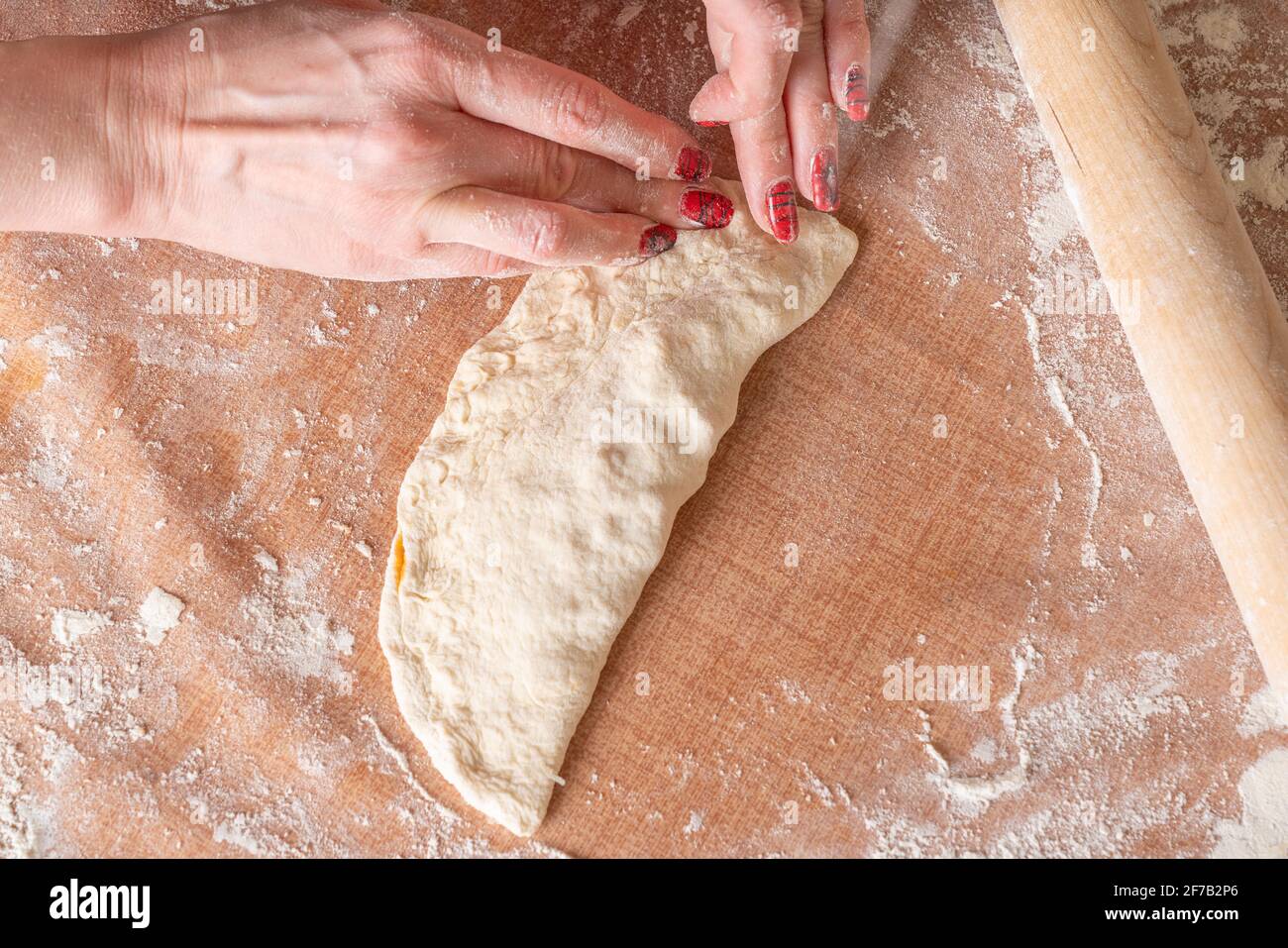 Making dough by female hands brown table background,view from above ...