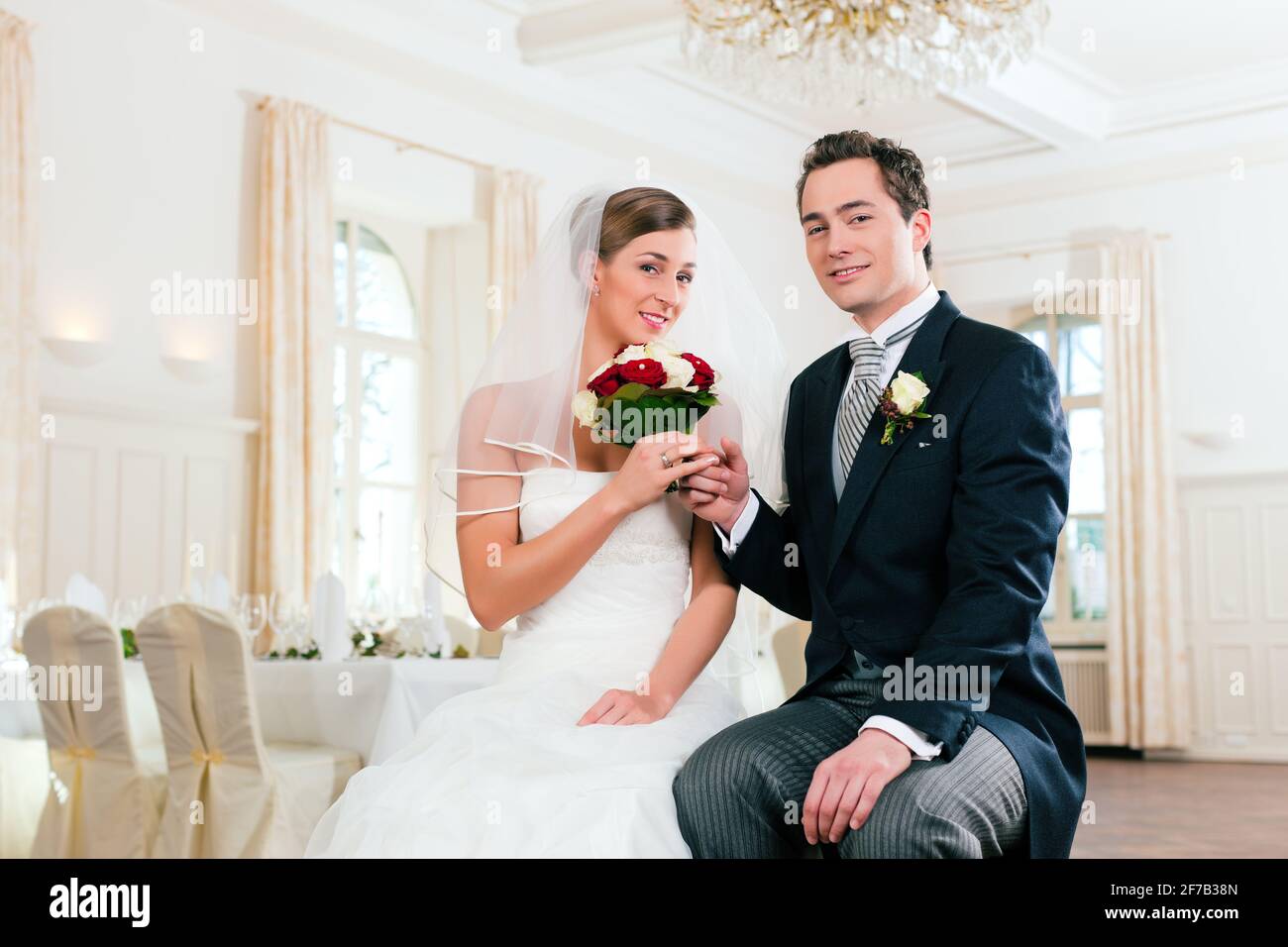 Bridal couple waiting for ceremony in a decorated hall Stock Photo - Alamy