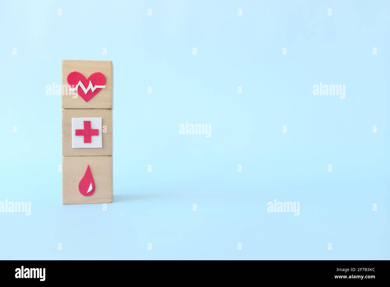 Healthcare icons on wooden blocks with copy space. Health top priority ...