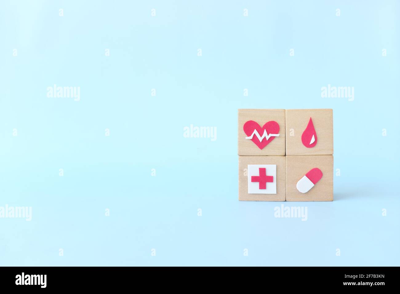 Healthcare icons on wooden blocks with copy space. Health top priority ...