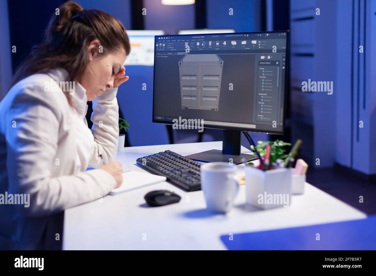 Focused architect working in 3D software developing prototype container ...