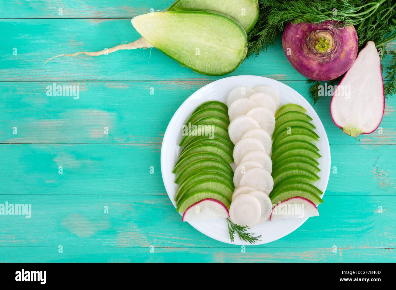 Different types of radish, sliced on a white plate. A useful vitamin ...
