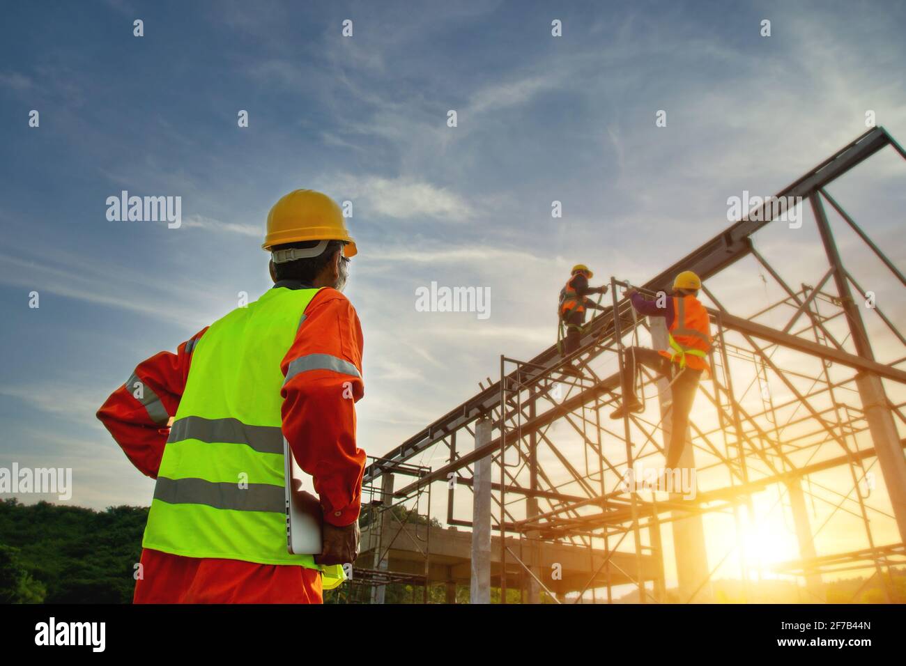 Asian construction worker control in the construction of roof ...