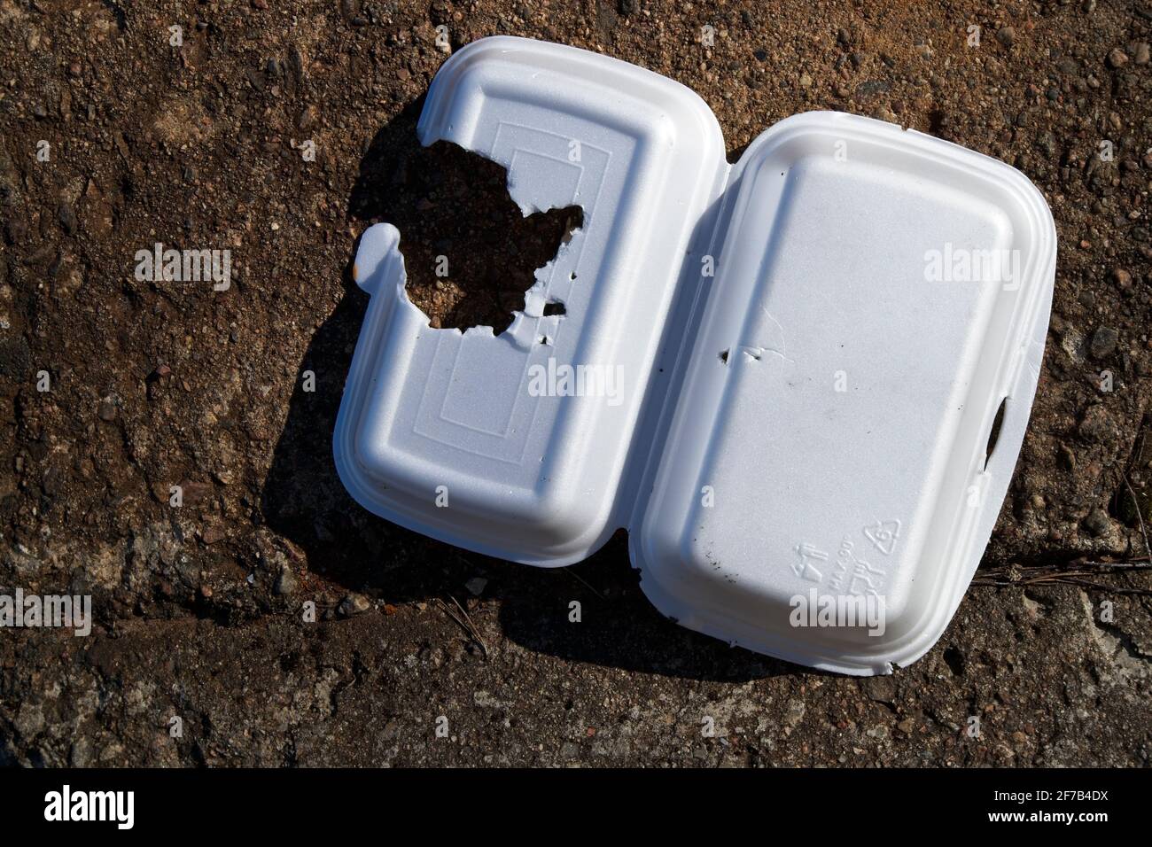 broken fast food polystyrene box on ground outdoors Stock Photo - Alamy
