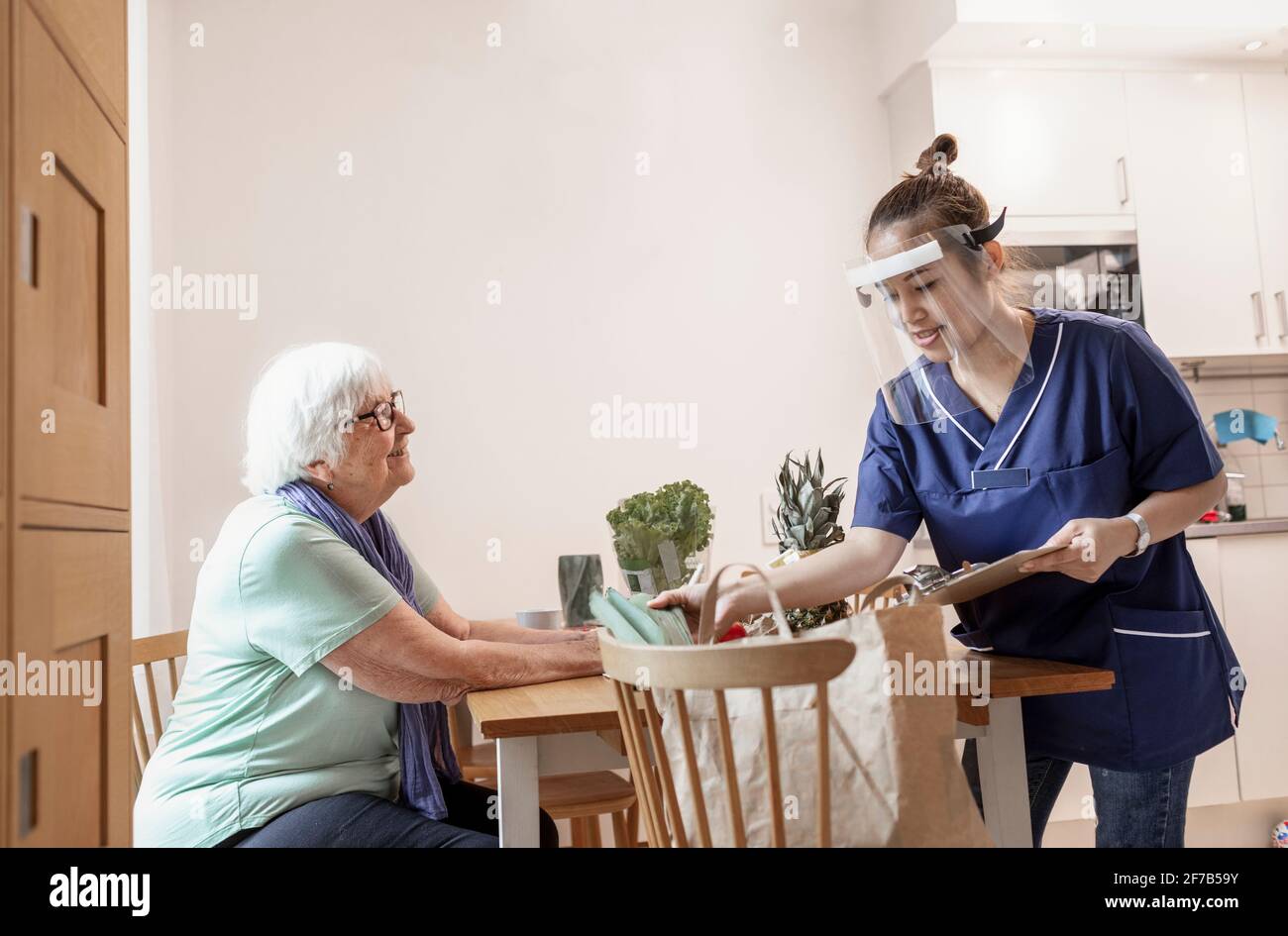 Home carer helping senior woman at home Stock Photo - Alamy
