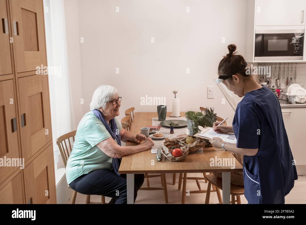 Home carer helping senior woman at home Stock Photo - Alamy