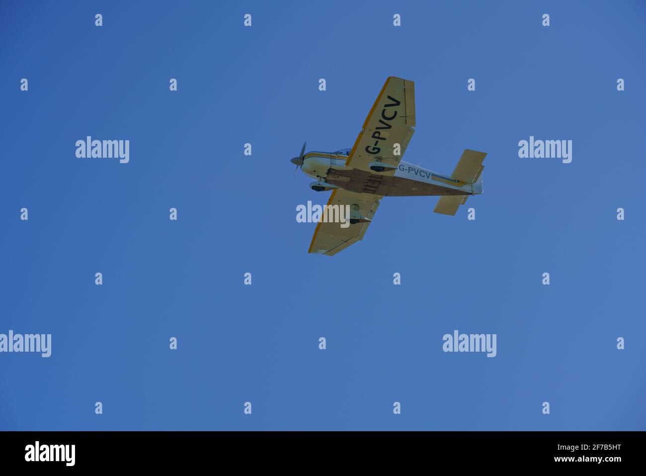 light aircraft coming in to land under a beautiful clear dark blue sky ...