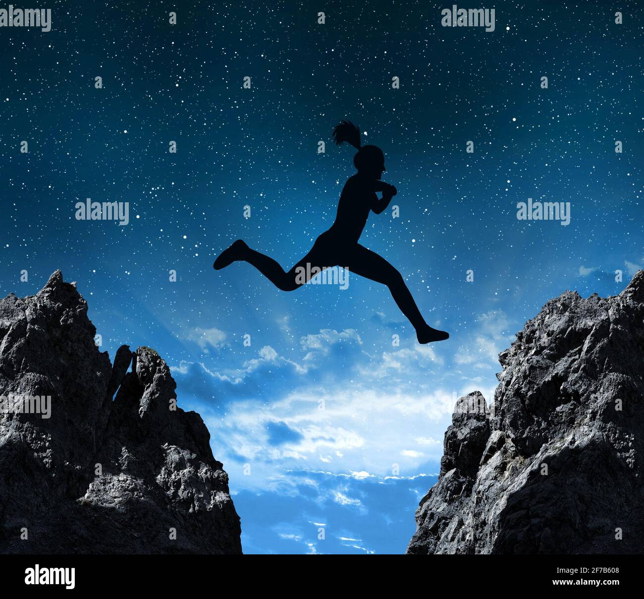 Silhouette the girl jumping through the gap between rock in night Stock ...