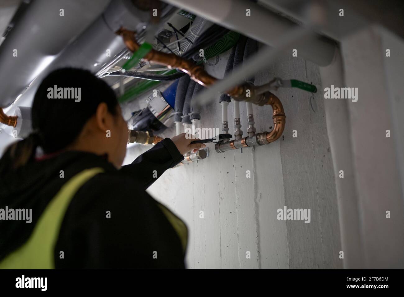 Female plumber fixing pipes Stock Photo - Alamy