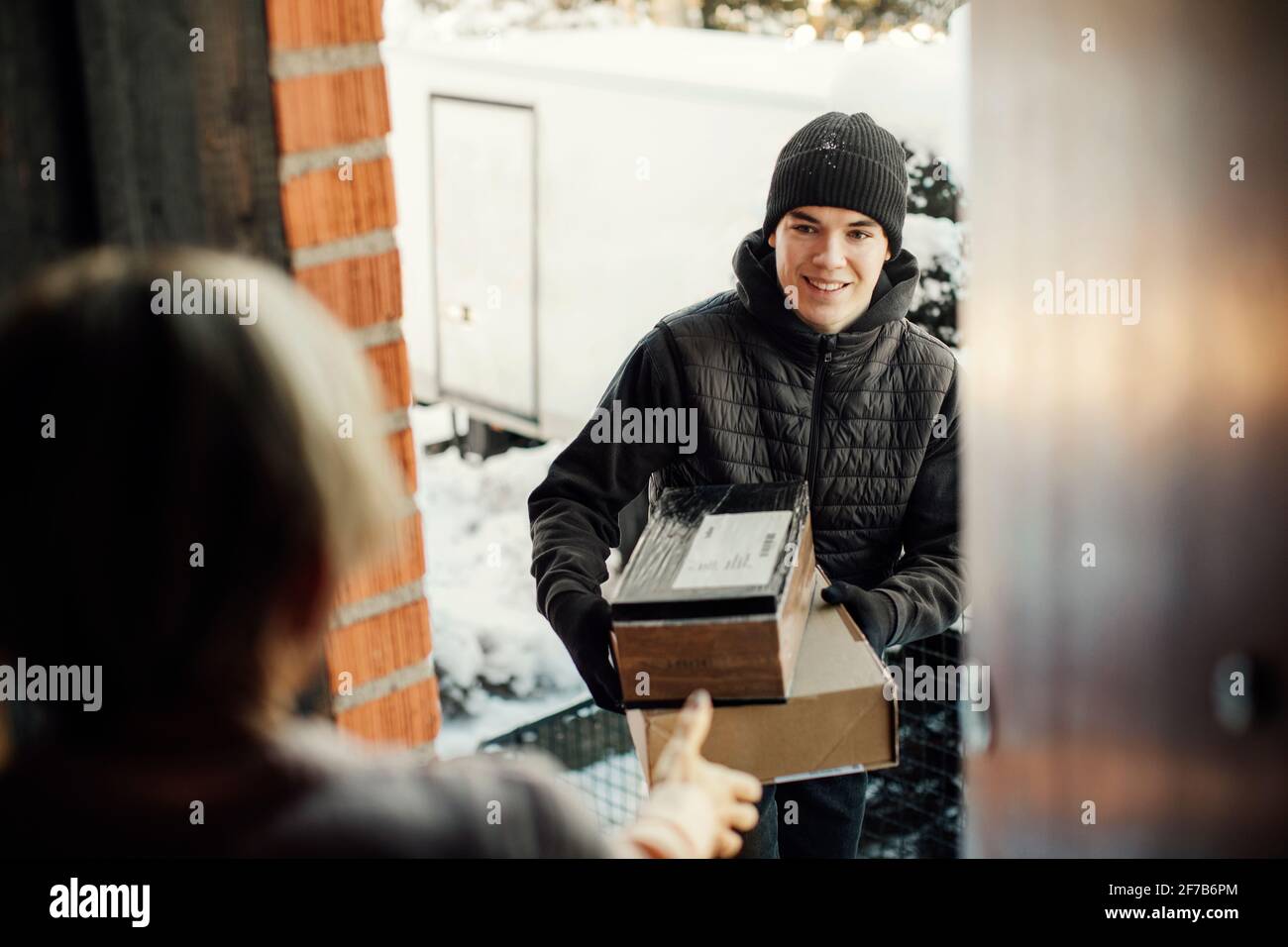 Courier delivering parcels Stock Photo - Alamy
