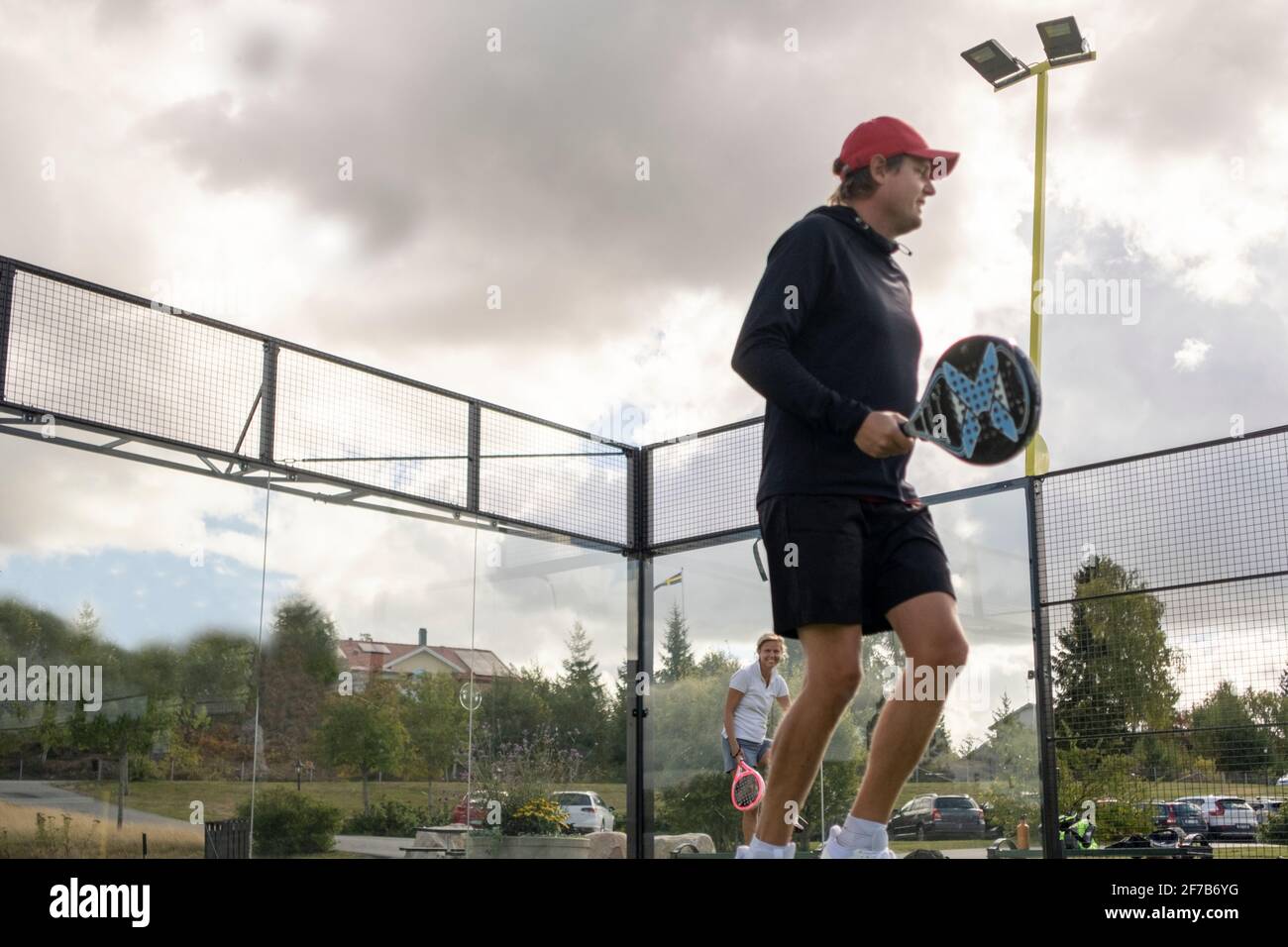 Man holding padel racket Stock Photo - Alamy