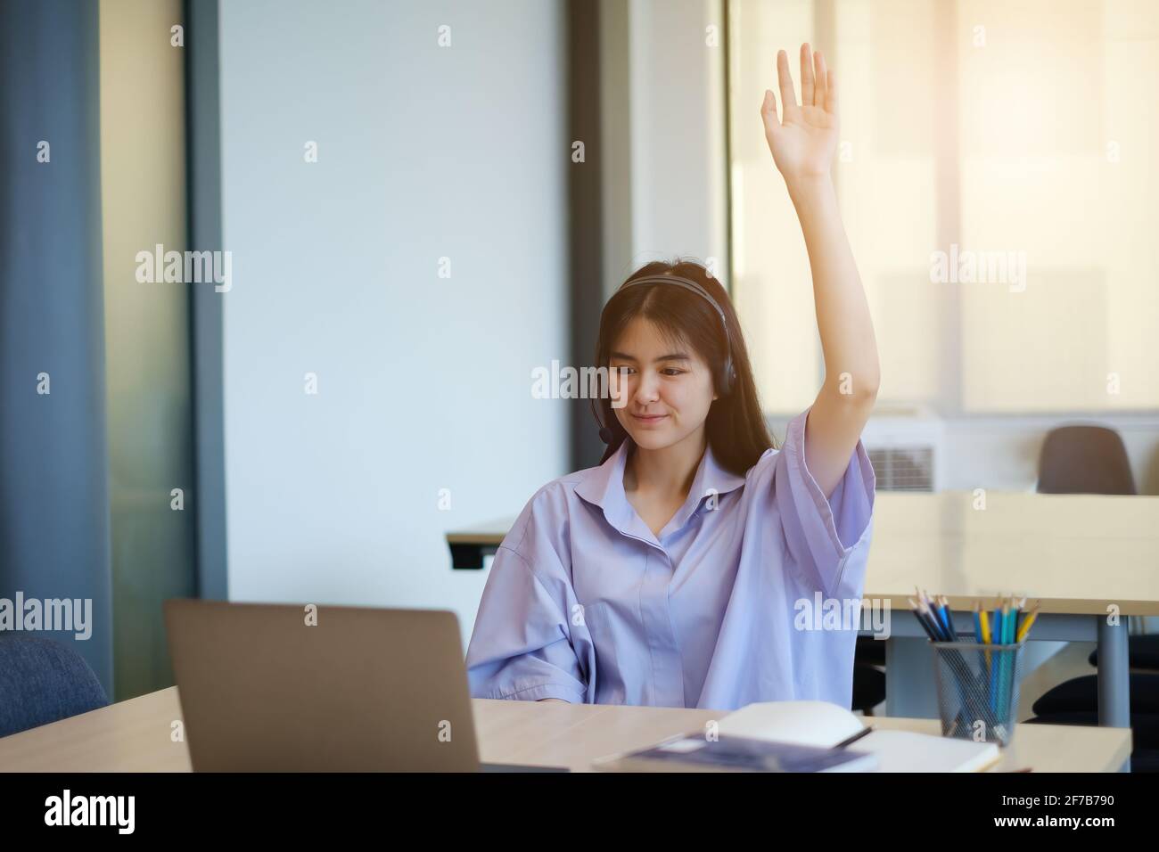 Happy student wave hand and have question while learning online sitting ...