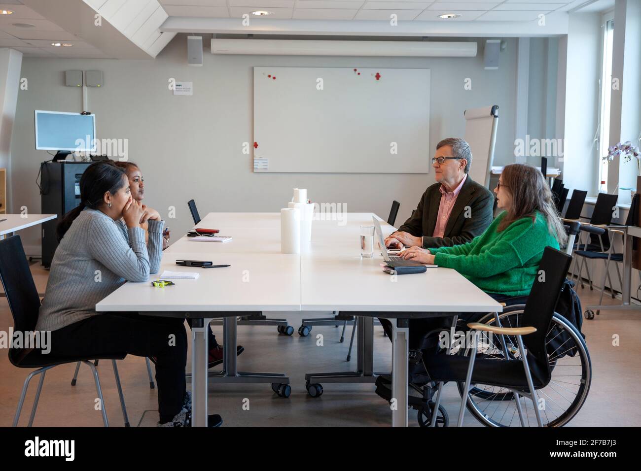 Disabled woman during meeting in office Stock Photo - Alamy