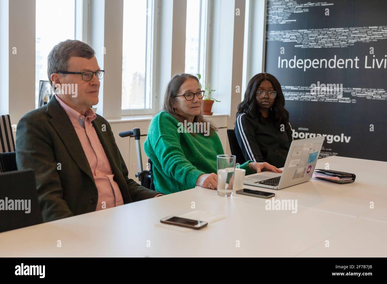 Disabled woman during meeting in office Stock Photo - Alamy