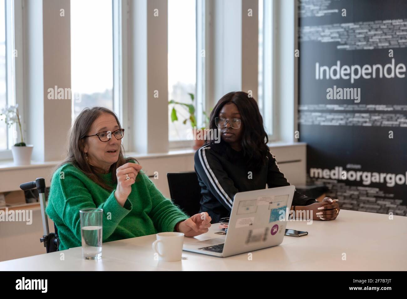 Disabled woman during meeting in office Stock Photo - Alamy