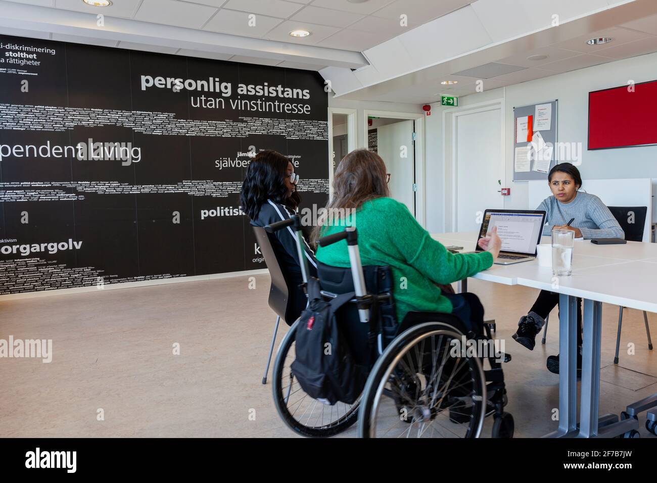 Disabled woman during meeting in office Stock Photo - Alamy