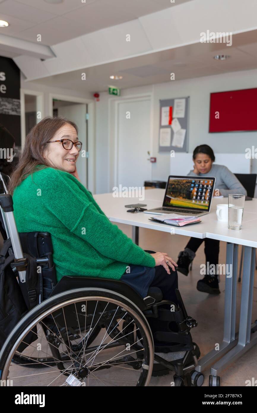 Disabled woman during meeting in office Stock Photo - Alamy