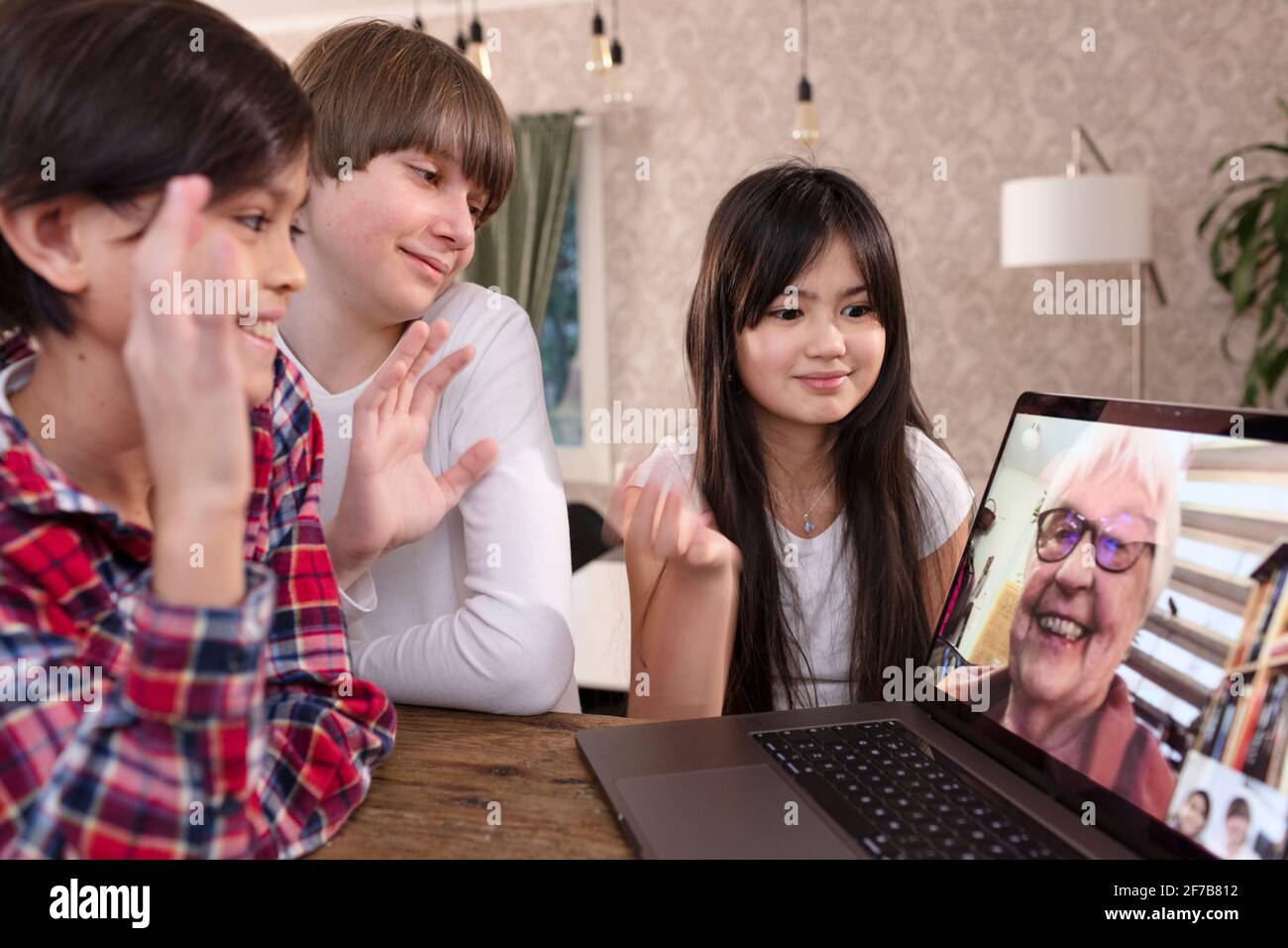 Grandchildren talking to grandmother via video call Stock Photo - Alamy