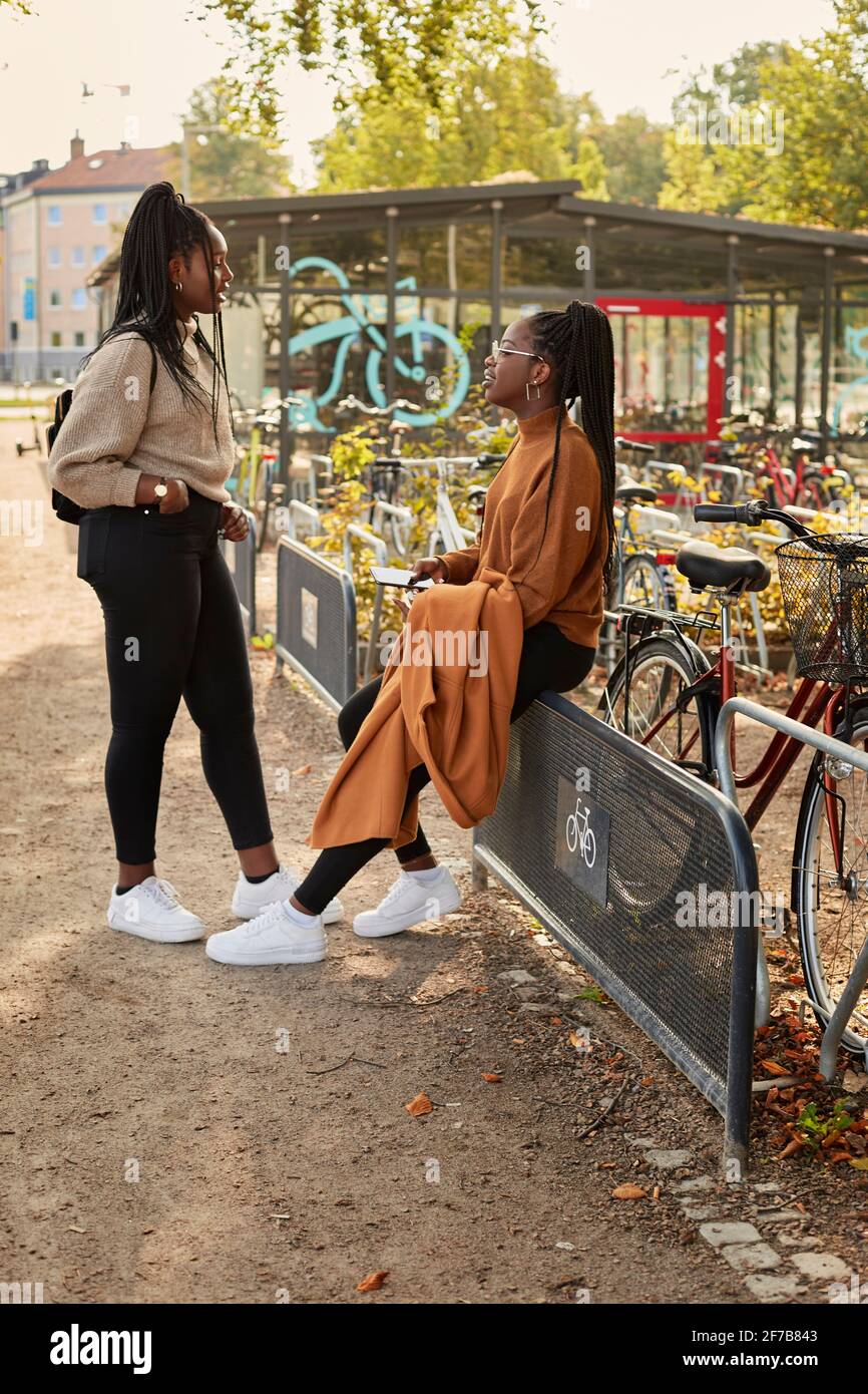 Female friends talking together Stock Photo - Alamy