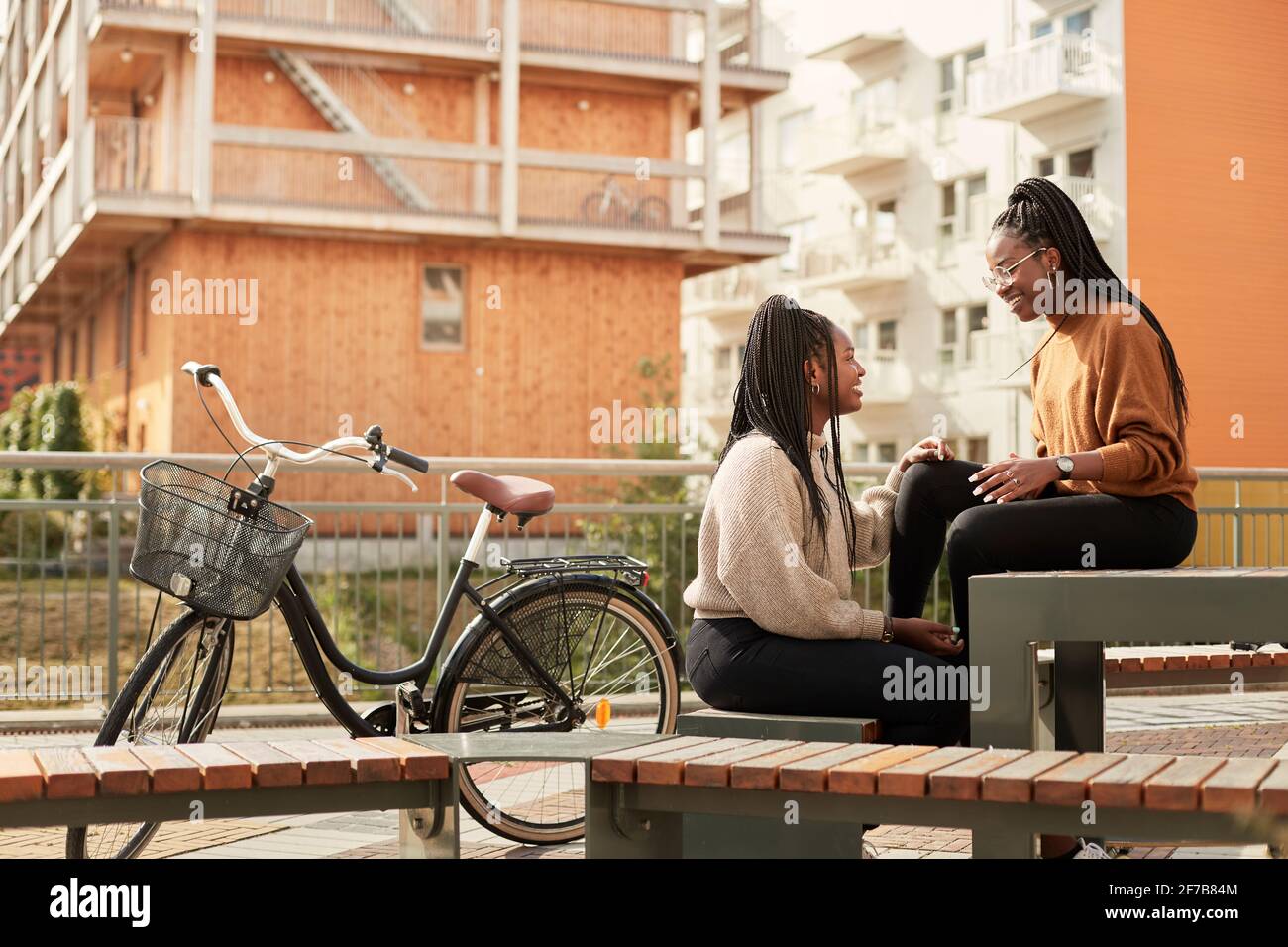 Female friends talking together Stock Photo - Alamy