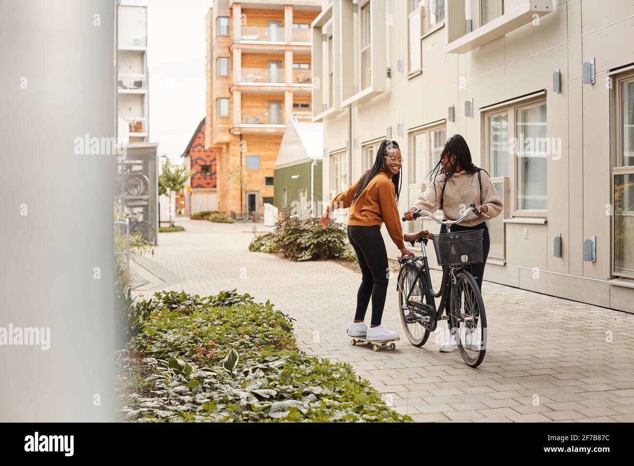 Female friends walking together Stock Photo - Alamy