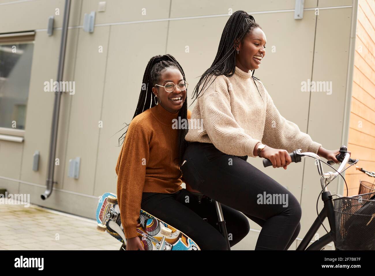 Female friends cycling Stock Photo - Alamy