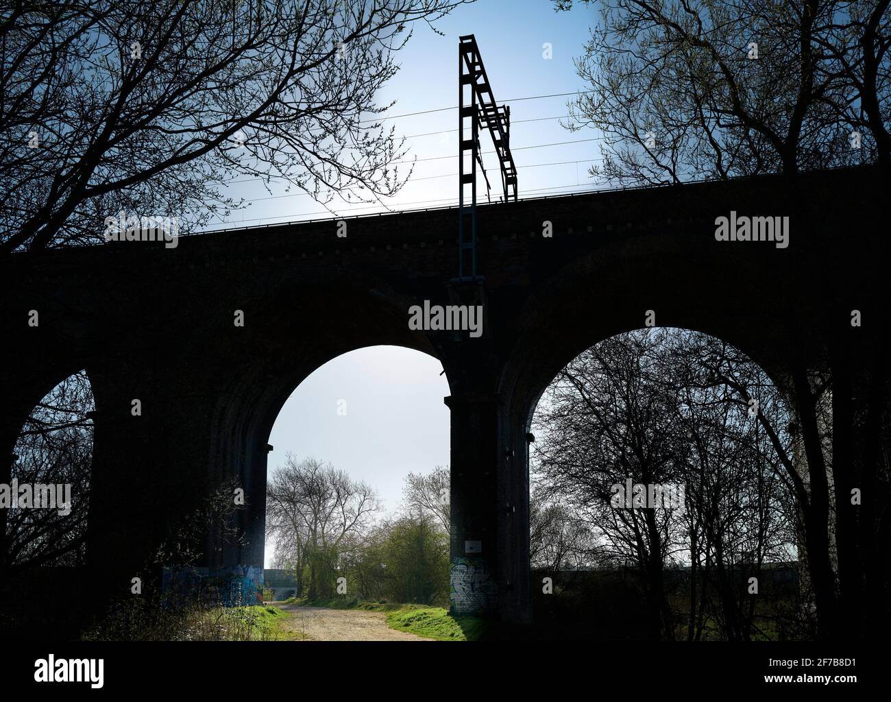 The newly electrified railway line on the victorian brick built rail ...