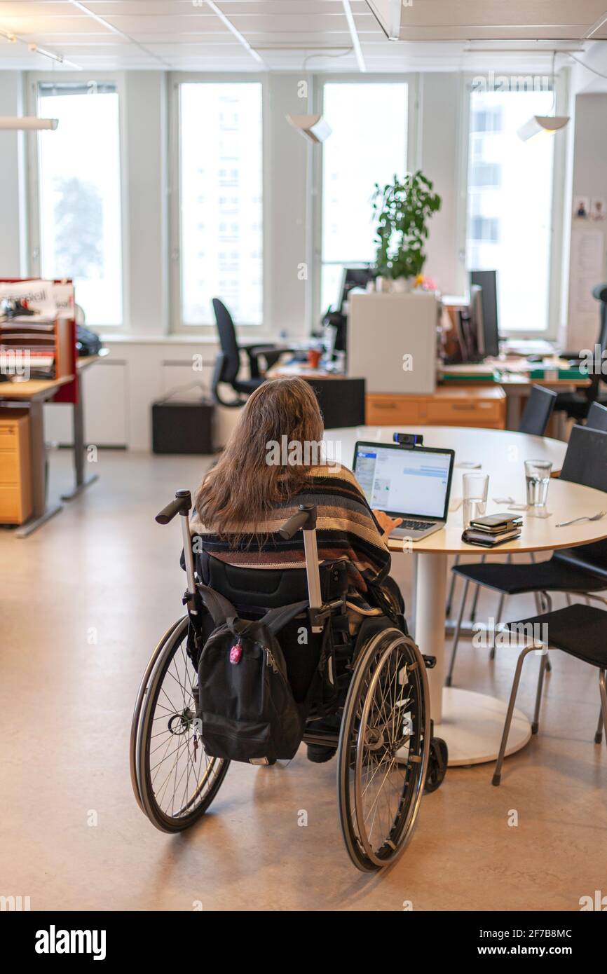 Disabled woman working in office Stock Photo - Alamy