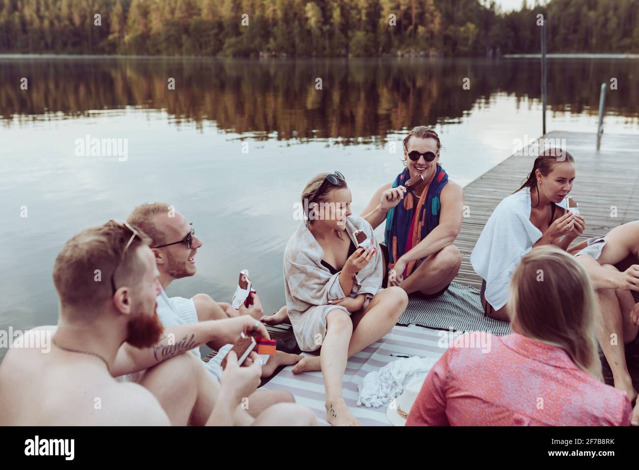 Friends relaxing at lake Stock Photo - Alamy