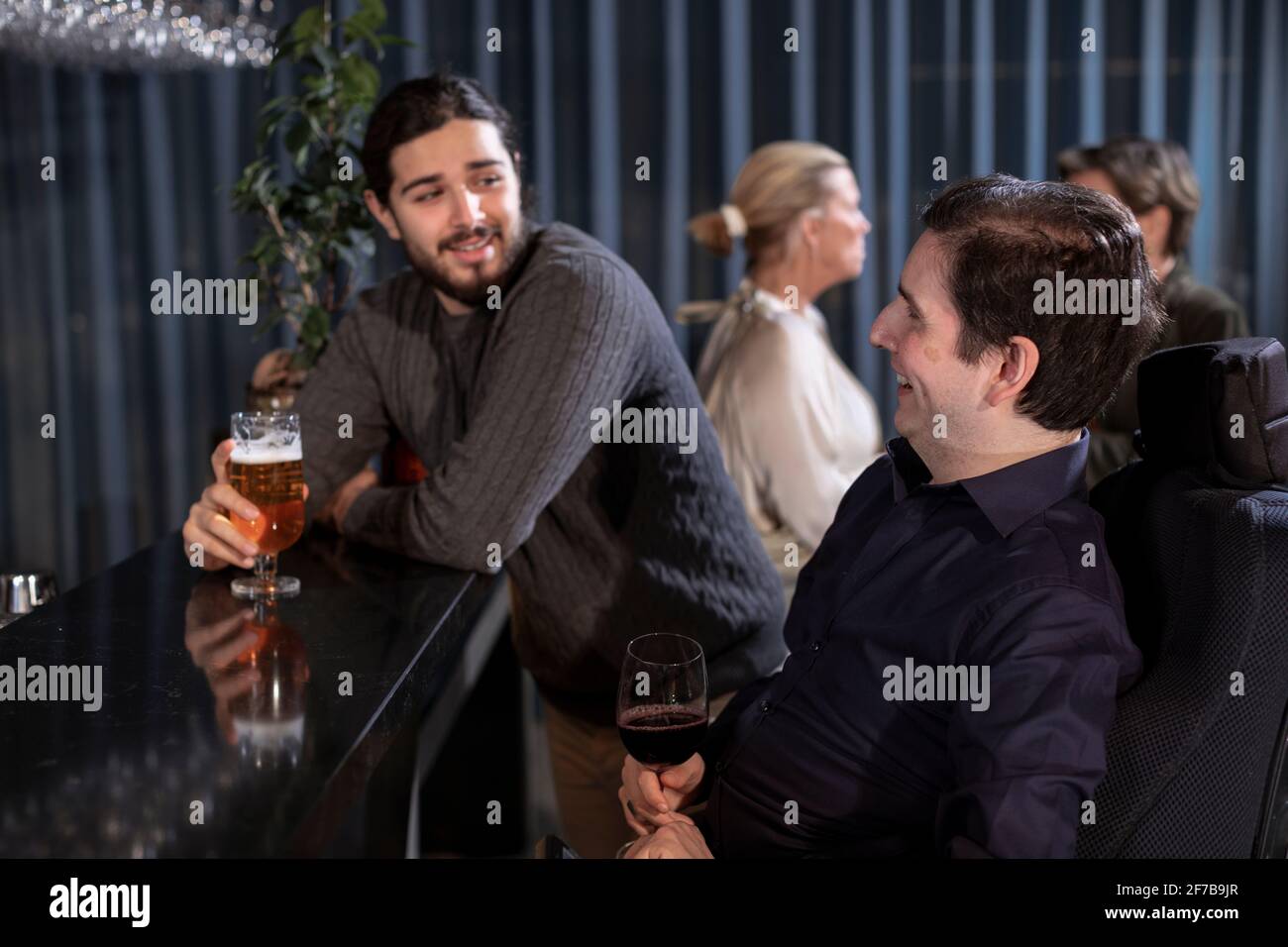 Male friends having beer together hi-res stock photography and images ...