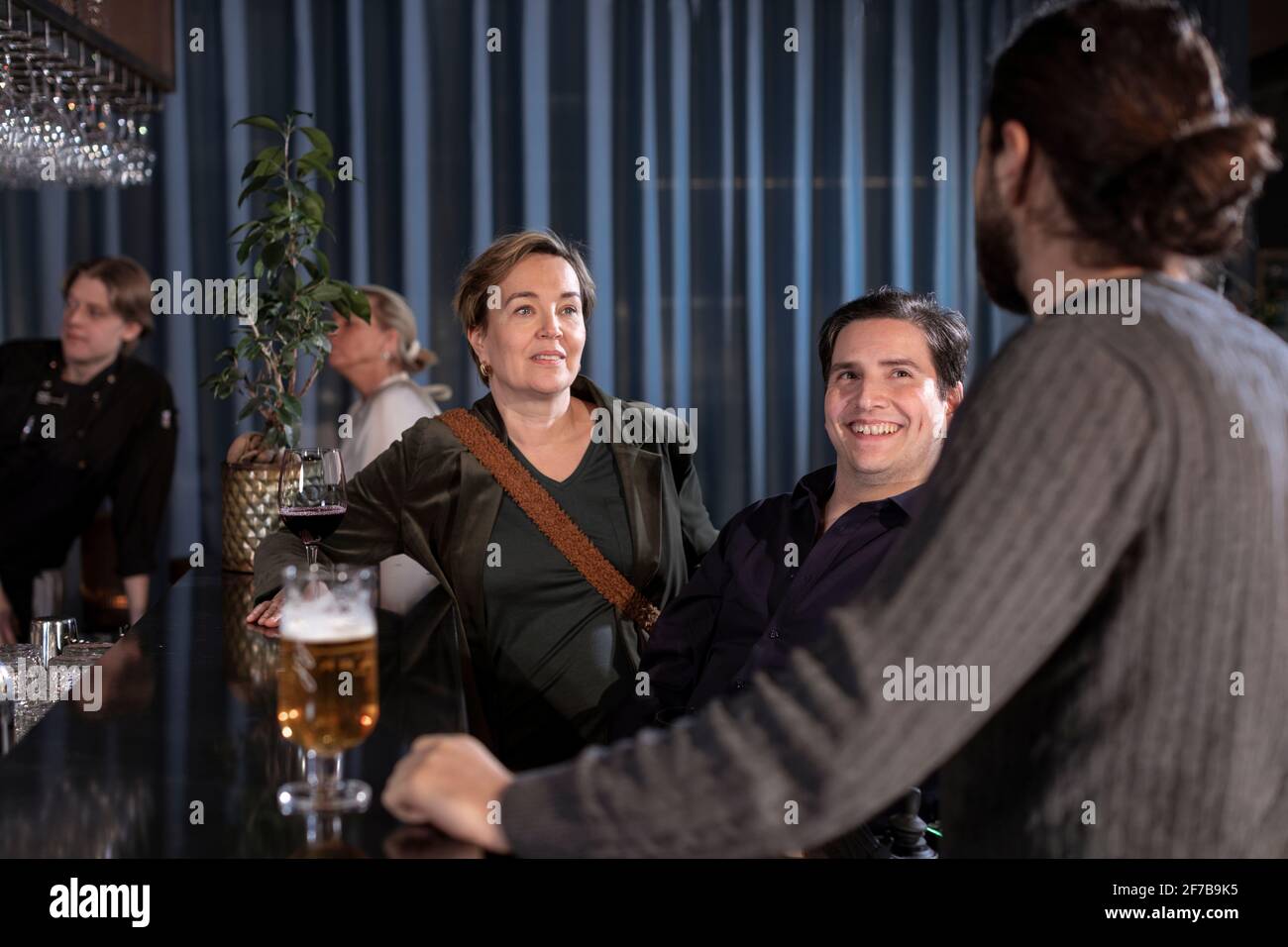 Group of friends having drink in bar Stock Photo - Alamy