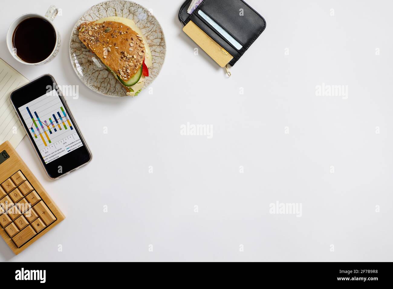 Sandwich and cell phone on desk Stock Photo - Alamy