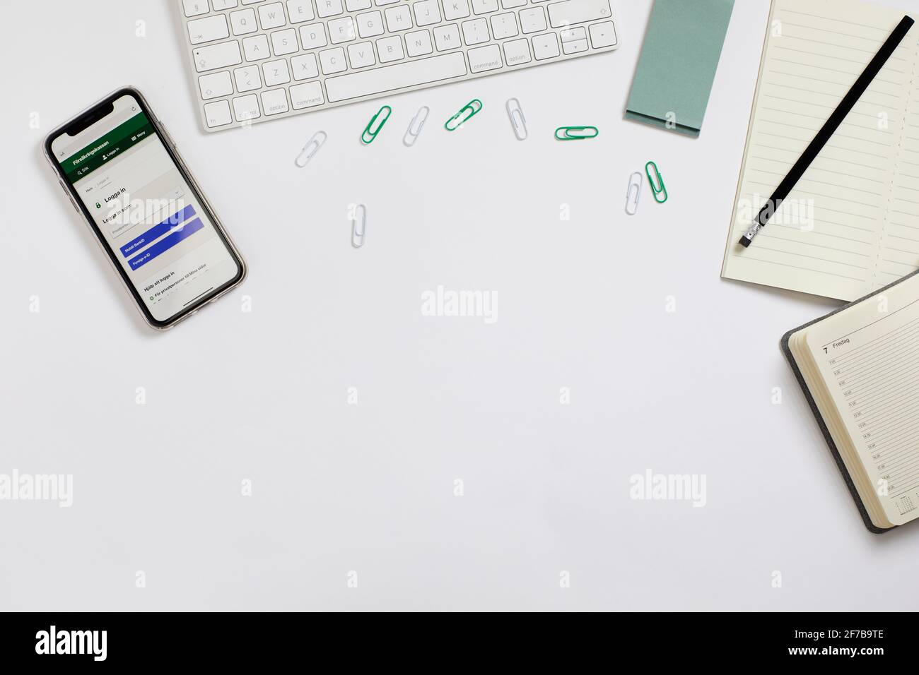 Cell phone on desk Stock Photo - Alamy