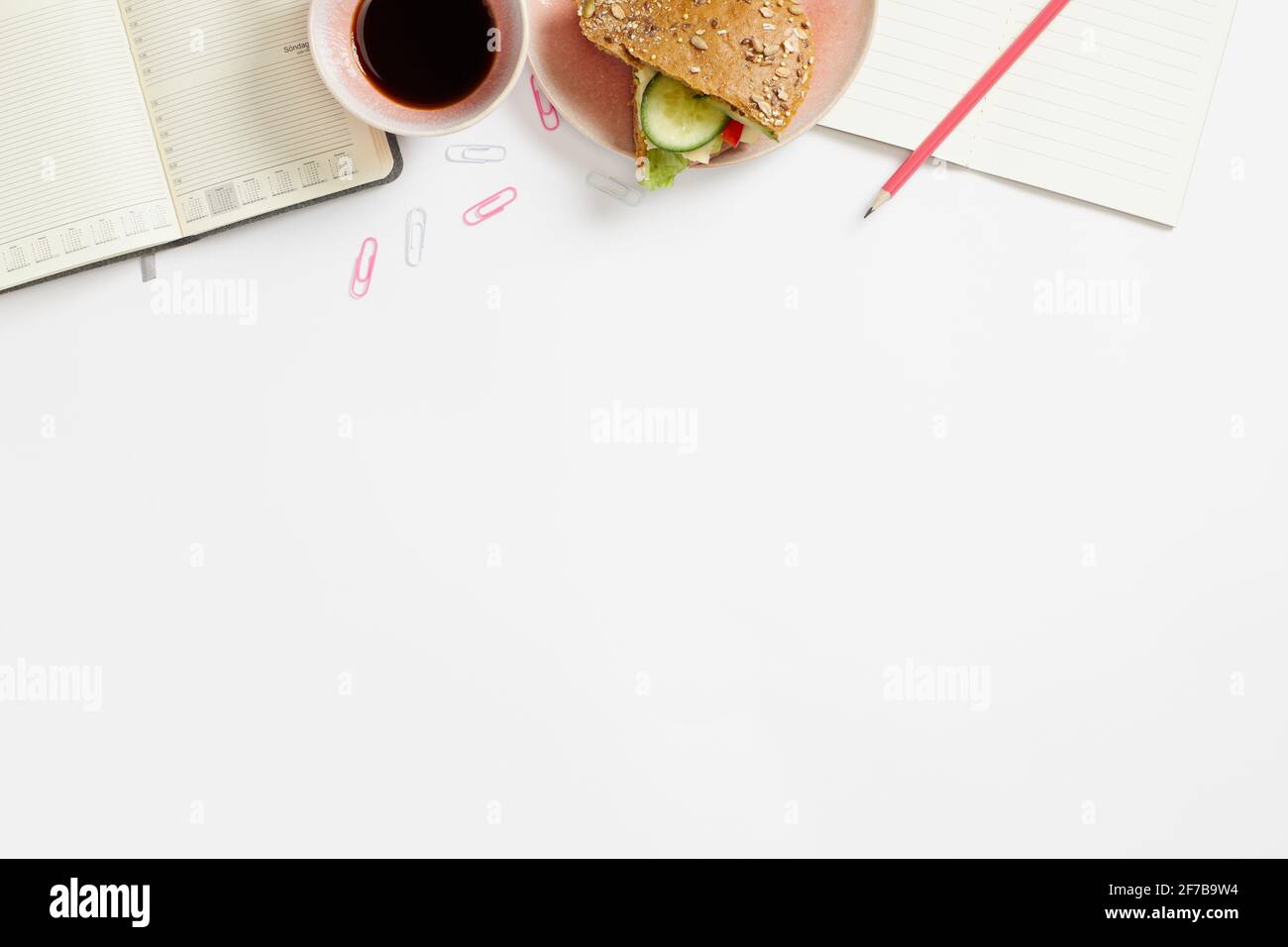 Sandwich and coffee on desk Stock Photo - Alamy