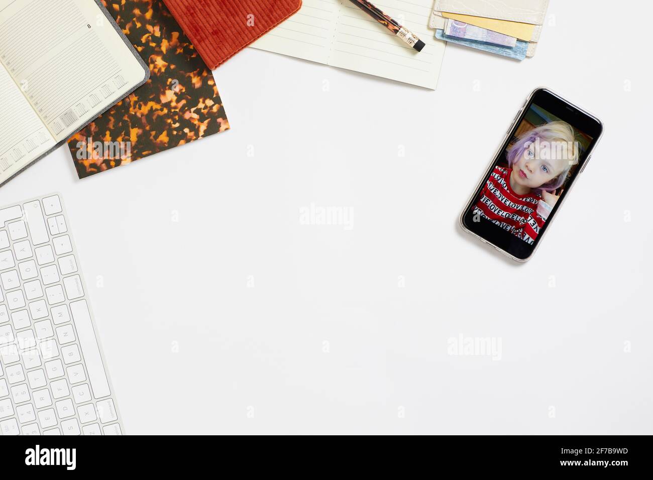 Cell phone on desk Stock Photo - Alamy