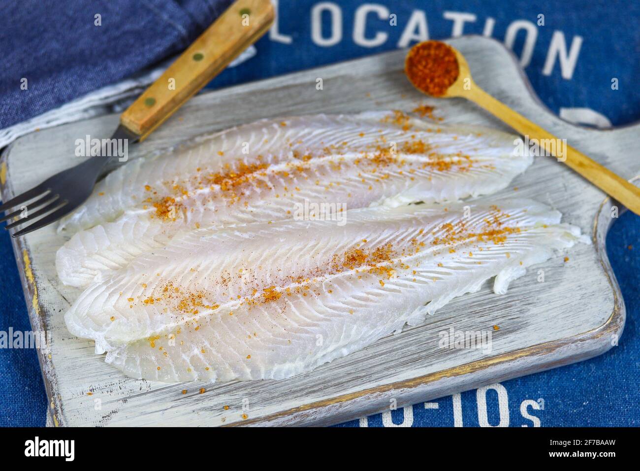 raw flounder fillet on a wooden board Stock Photo - Alamy