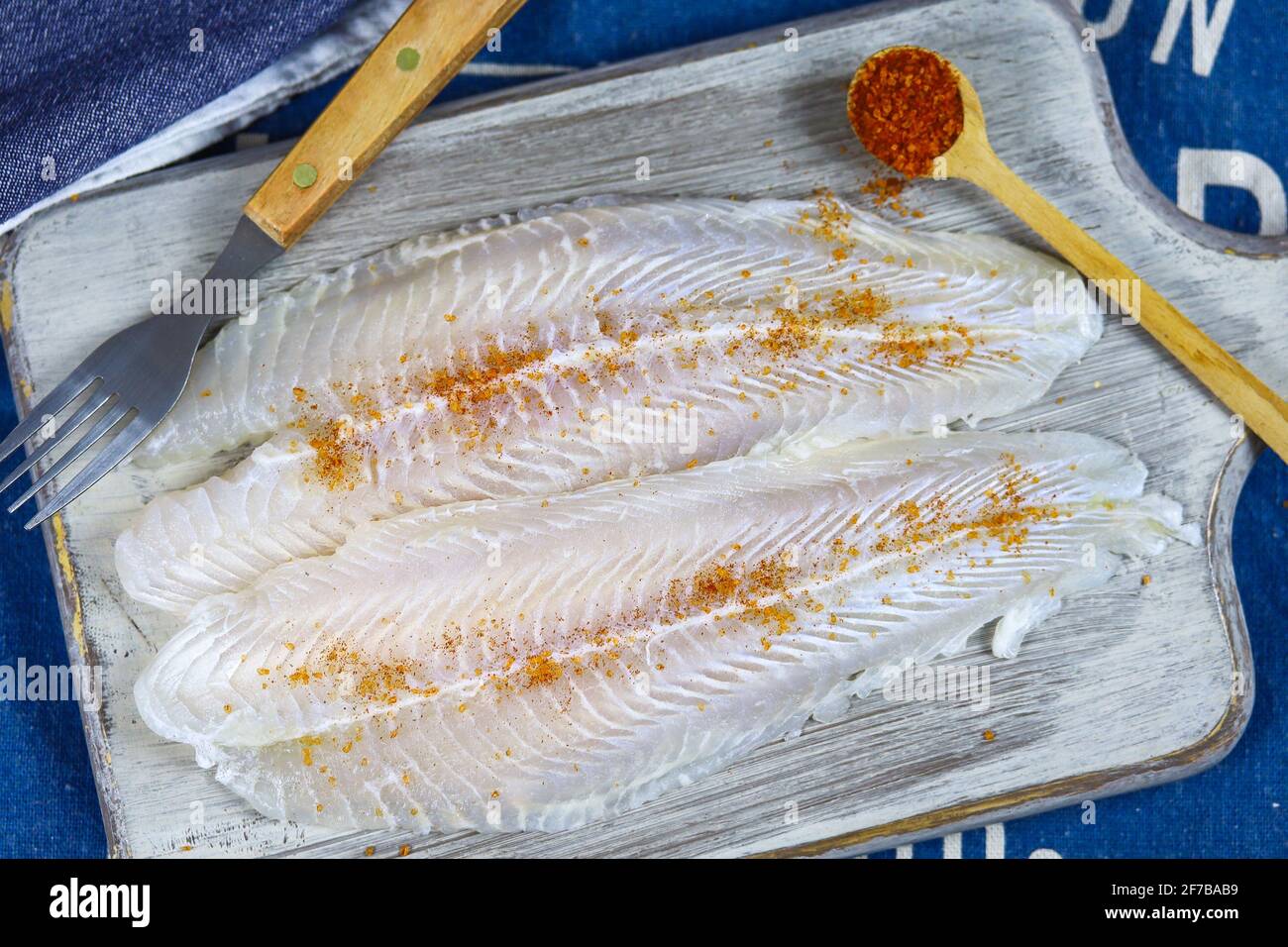 raw flounder fillet on a wooden board Stock Photo - Alamy