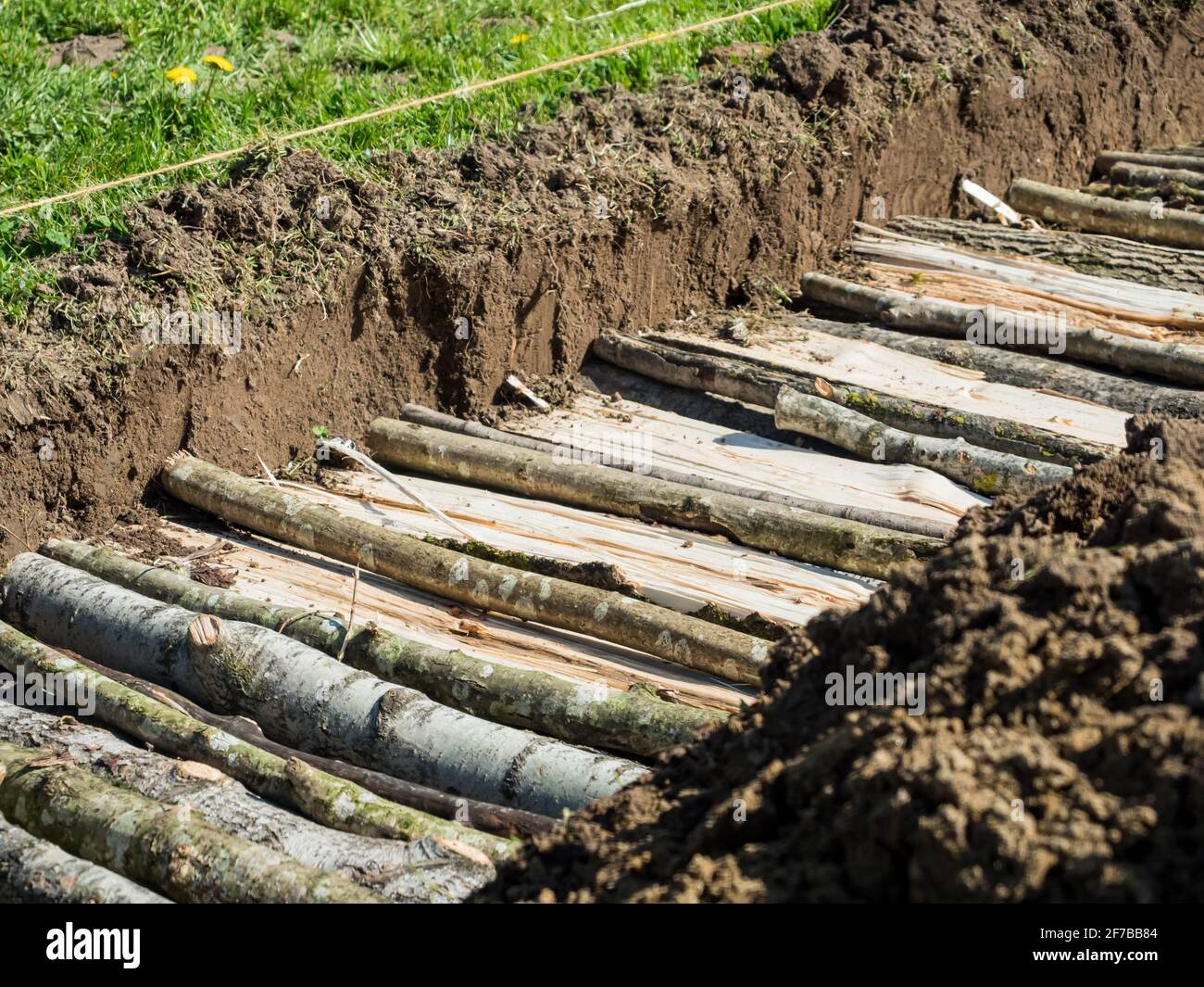 Permaculture trench construction close up with green grass side Stock ...