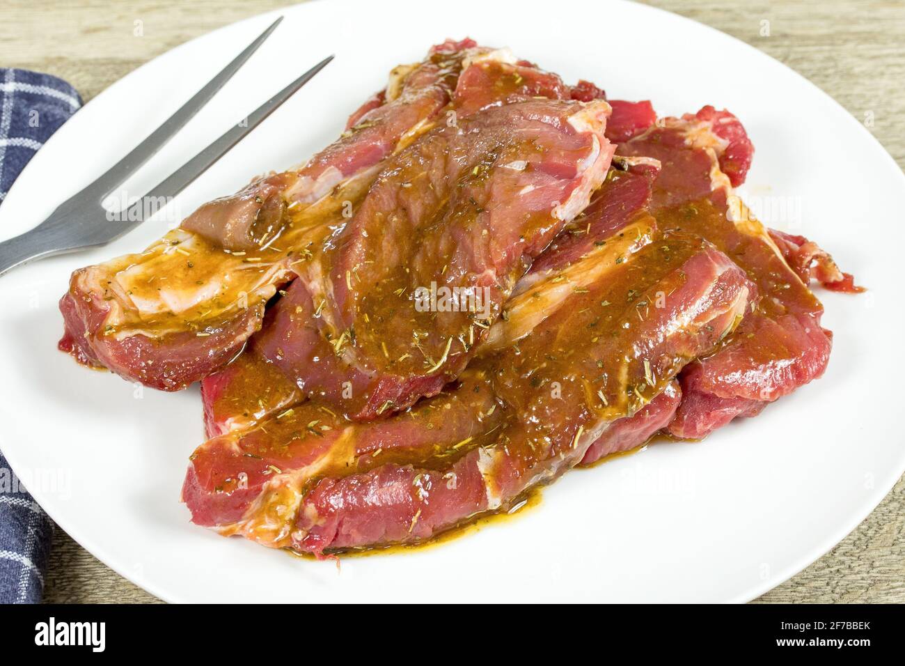marinated steak in a white plate Stock Photo - Alamy