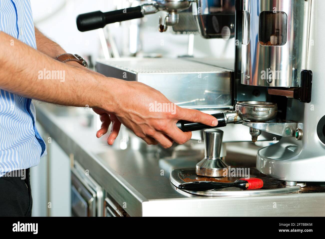 Barista prepares espresso in his coffeeshop; close-up Stock Photo - Alamy