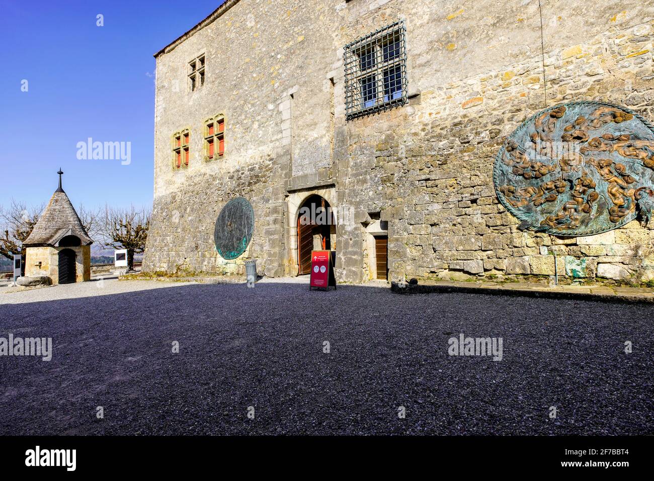 Entrance to medieva Castle of Gruyères decorated by Giant metal plaques ...