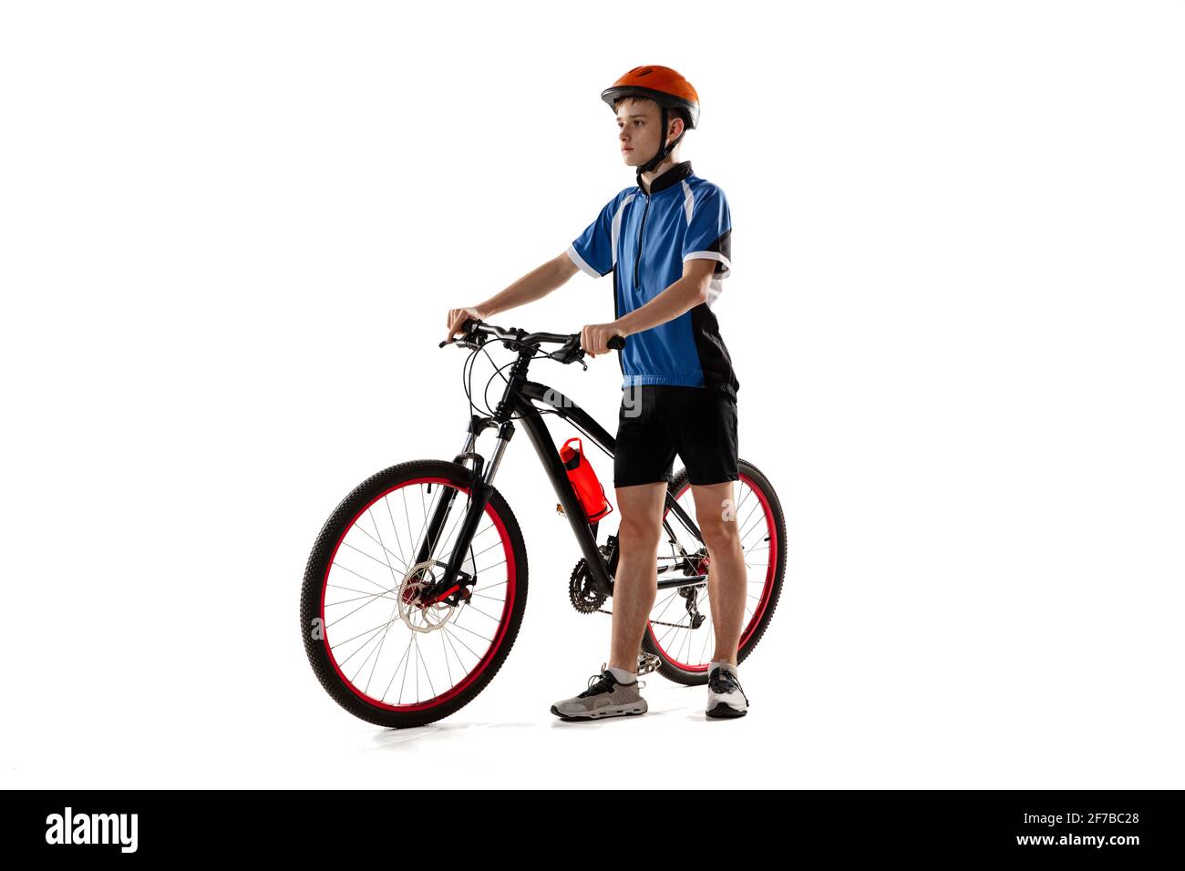 Young Caucasian boy bike rider with road bike isolated over white ...